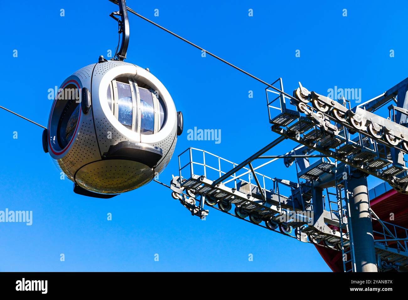 a cable car with round passenger cabins. cable car against blue sky ...