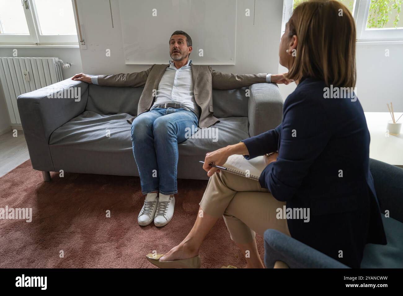 Male patient with expressive body language during therapy session with ...