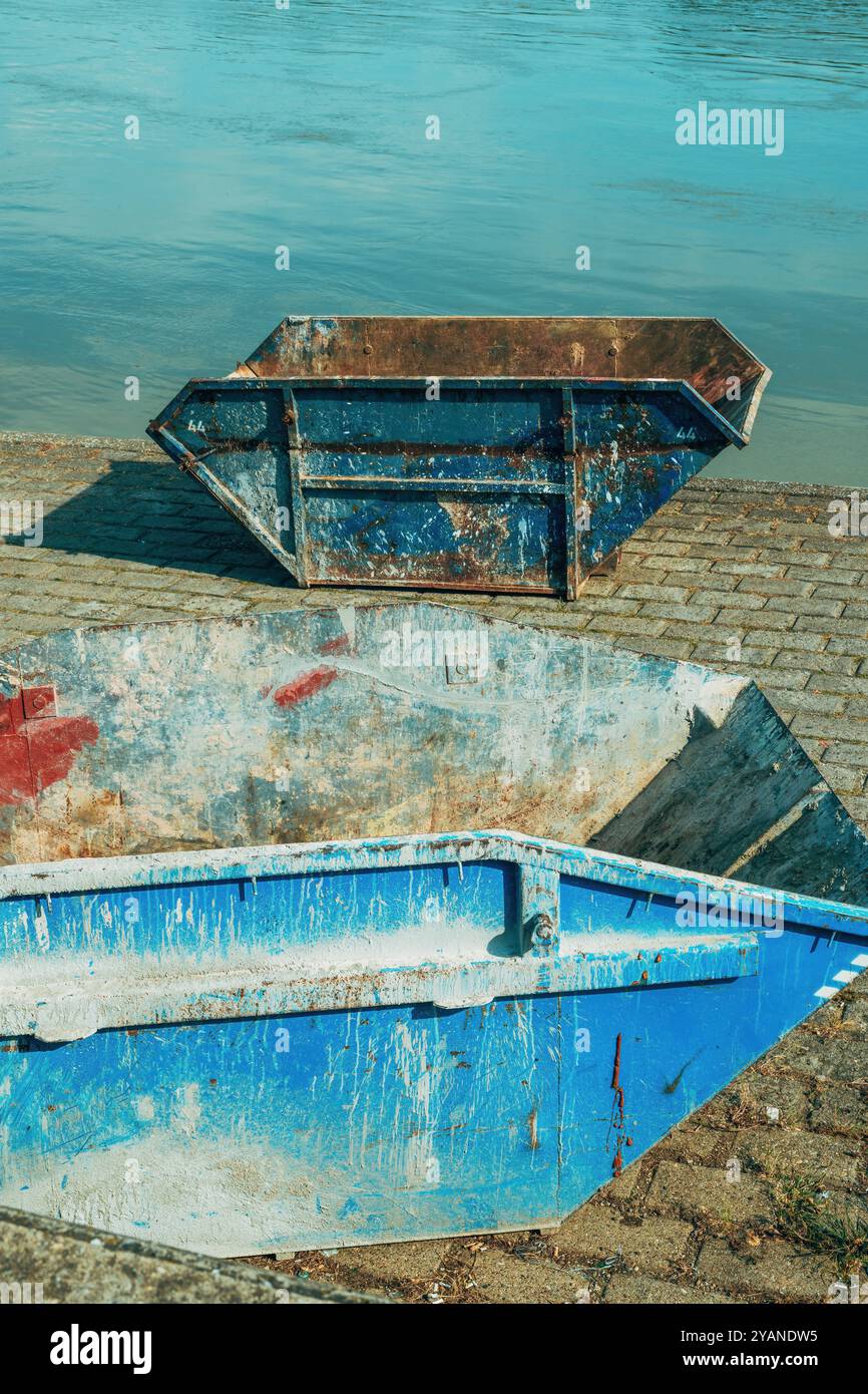 Old worn skip container on riverbank, selective focus Stock Photo - Alamy
