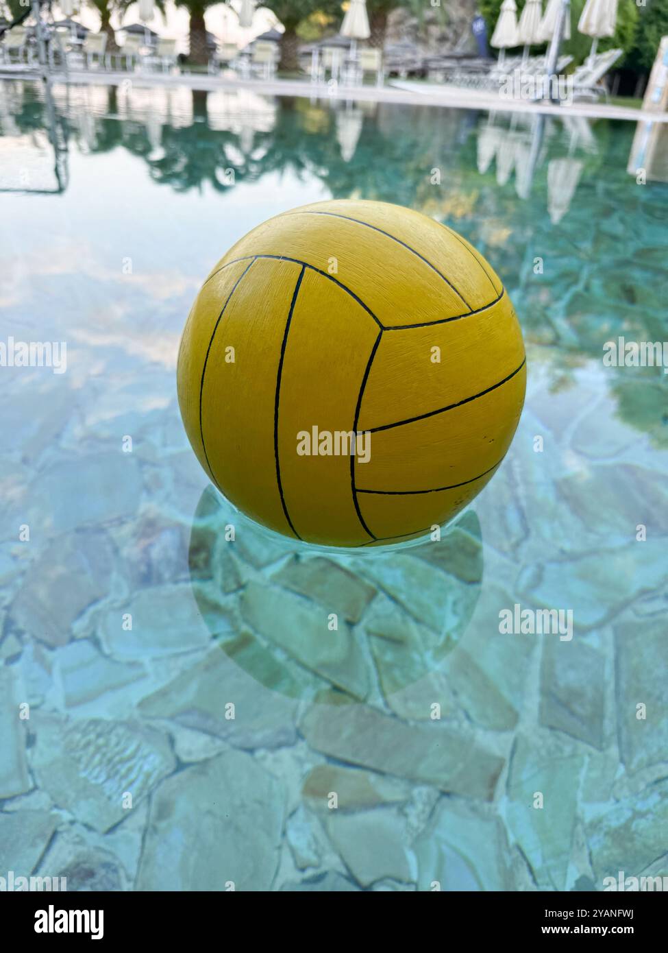 Water polo. Yellow water polo ball in a swimming pool in hotel on the ...