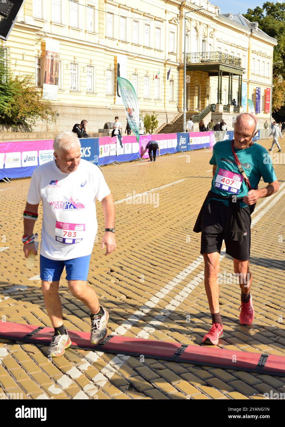 Old man senior runner crossing the finish line as participant in the ...
