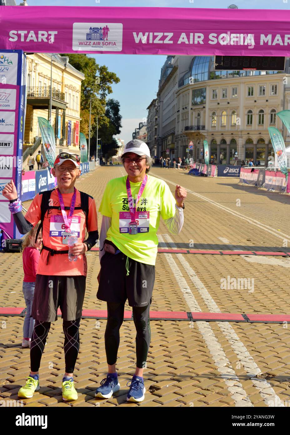 Asian participants posing for photos in the traditional annual marathon sponsored by Wizz Air in ...