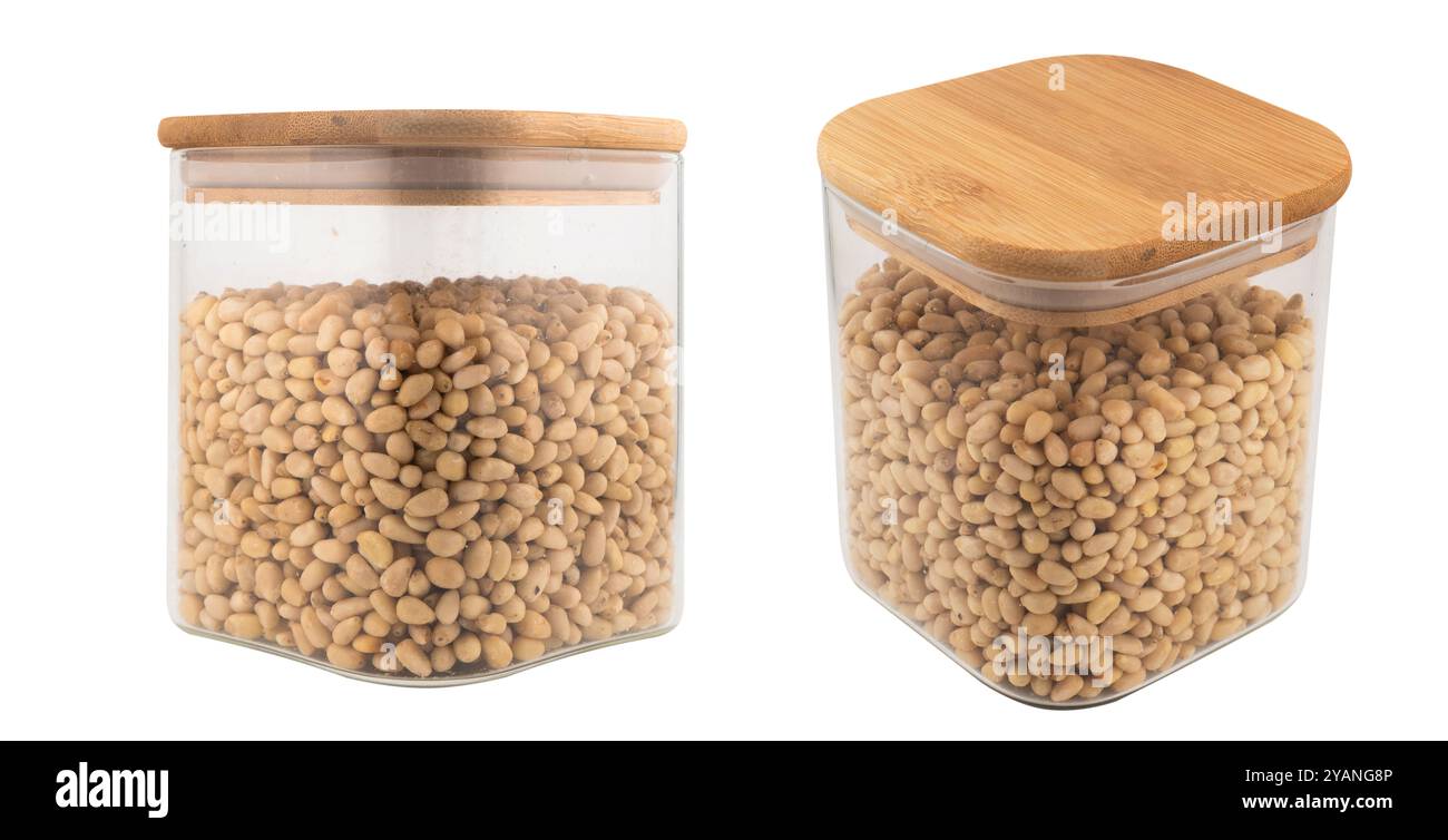 Cedar nuts in glass jar isolated on white background. Transparent glass ...