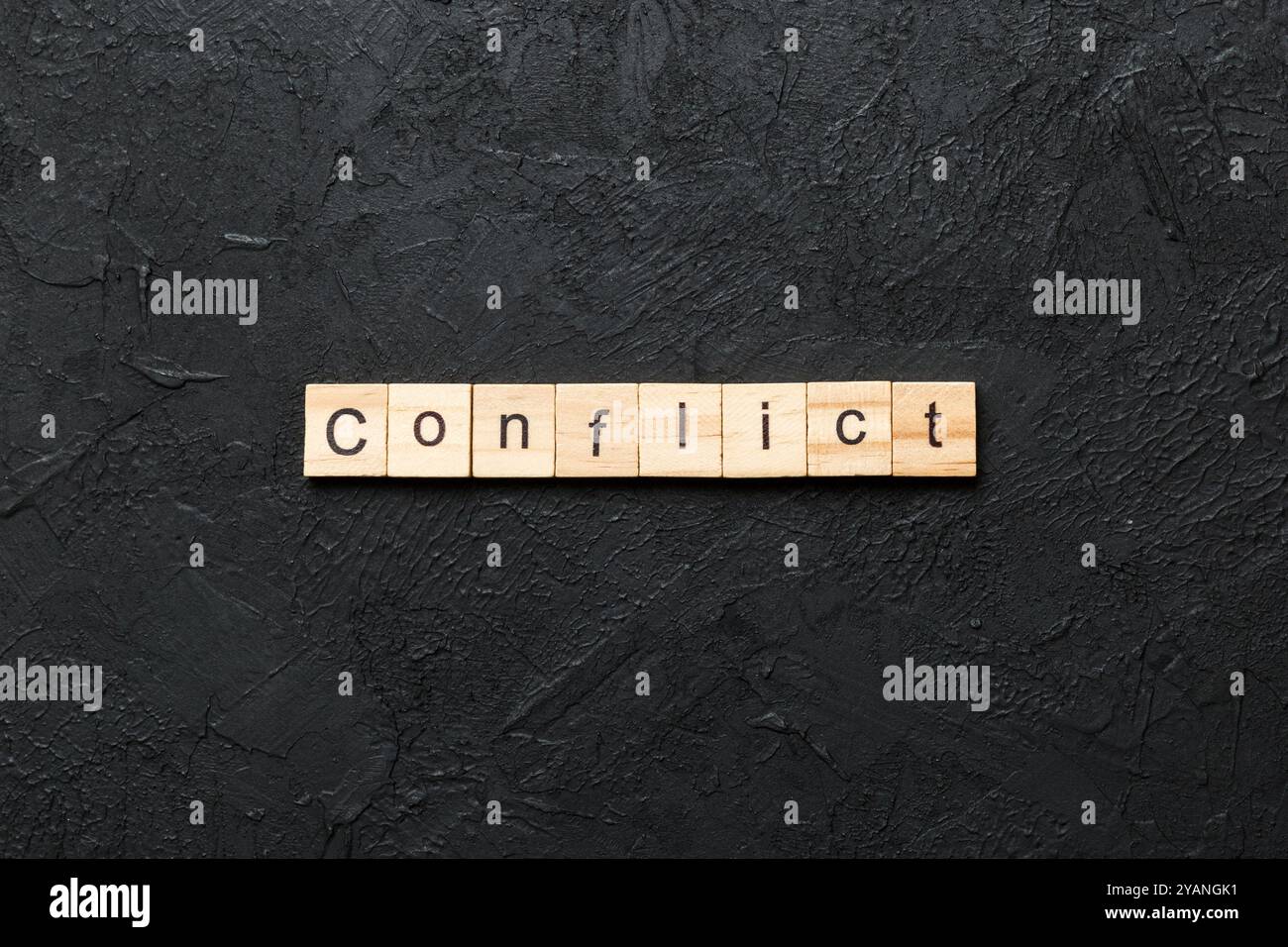CONFLICT word written on wood block. CONFLICT text on cement table for ...