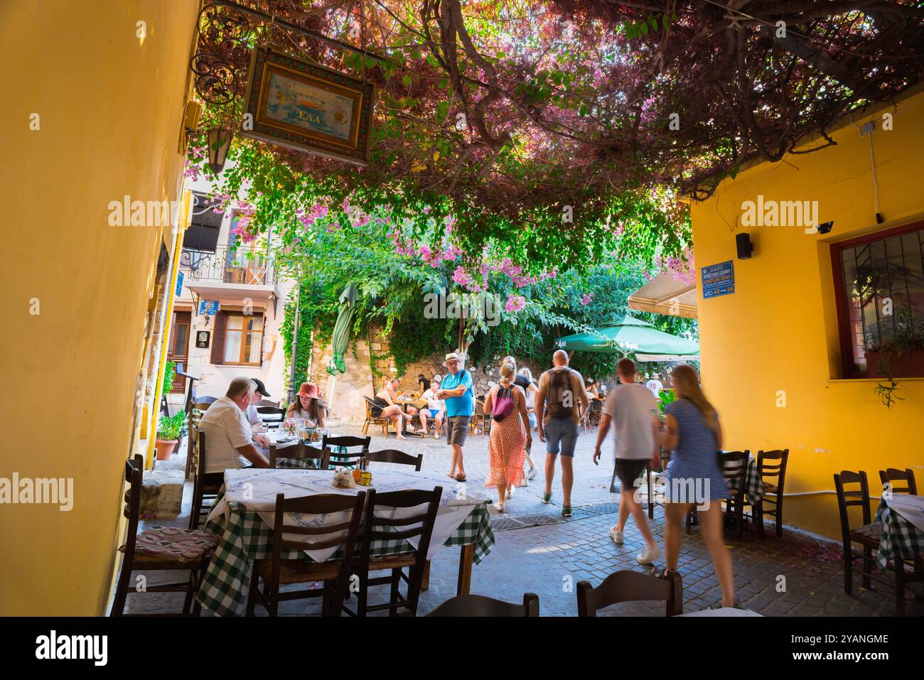 Chania Old Town, view of people walking past restaurant tables sited in ...