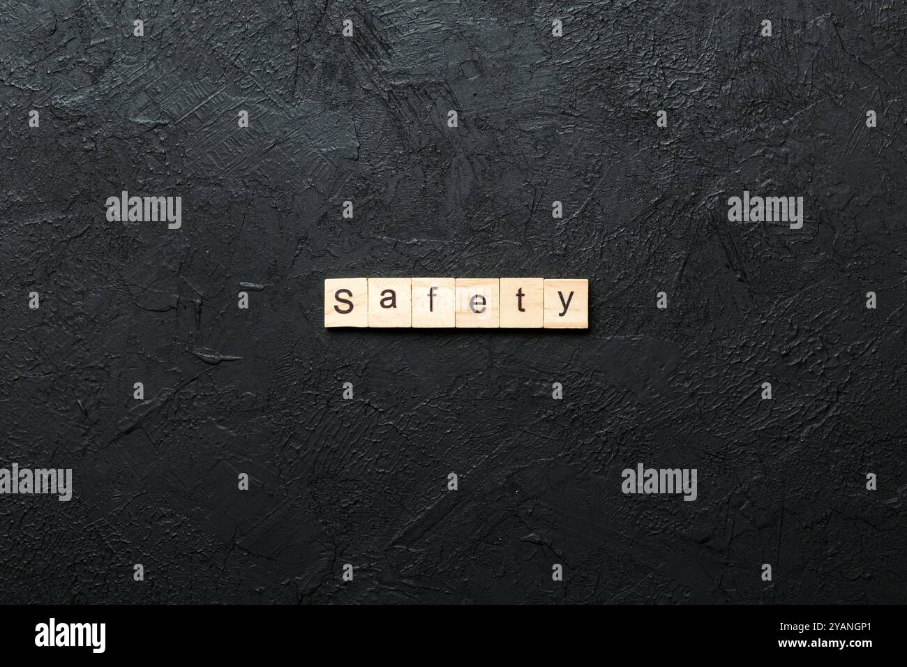 safety word written on wood block. safety text on cement table for your ...