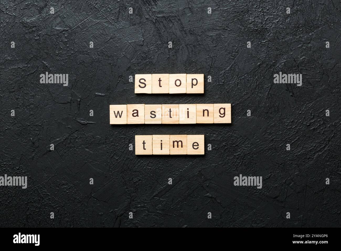 Stop wasting time word written on wood block. Stop wasting time text on ...
