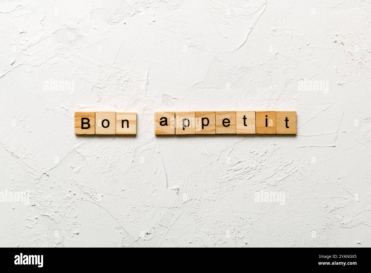 Bon Appetit word written on wood block. Bon Appetit text on cement ...