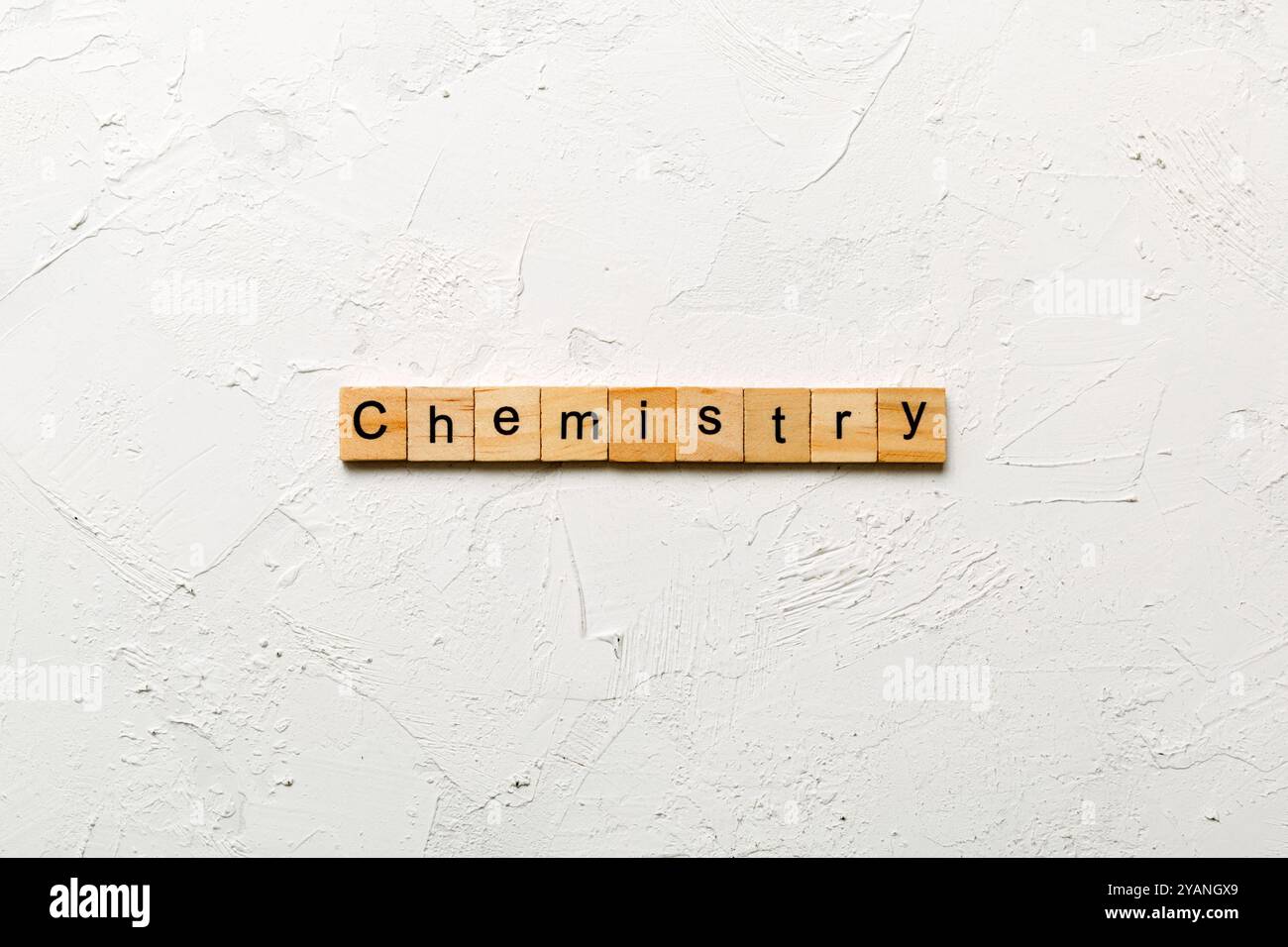 Chemistry word written on wood block. Chemistry text on cement table ...