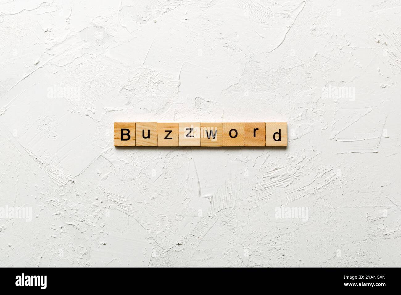 BUZZWORD word written on wood block. BUZZWORD text on cement table for ...
