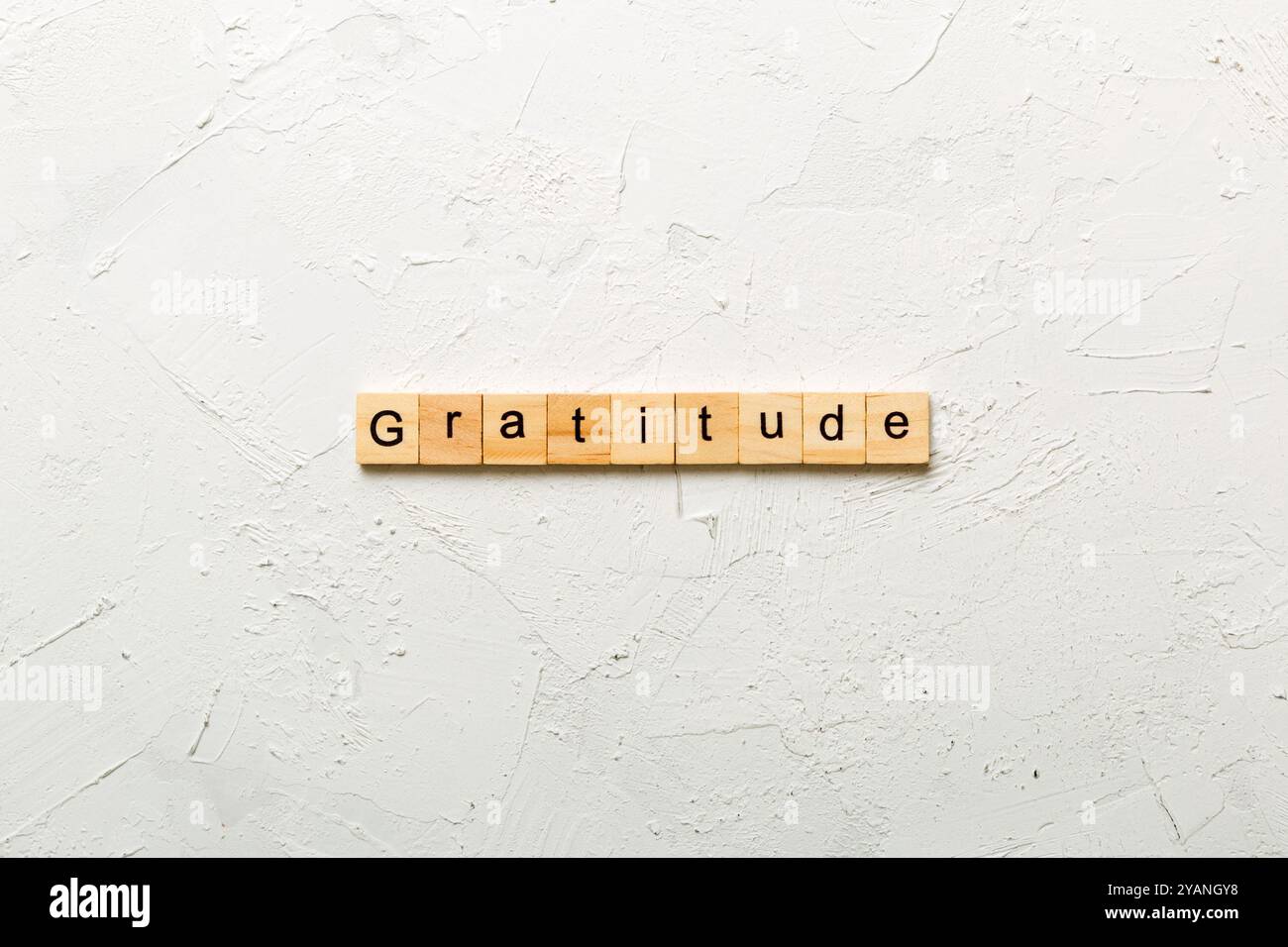 gratitude word written on wood block. gratitude text on cement table ...