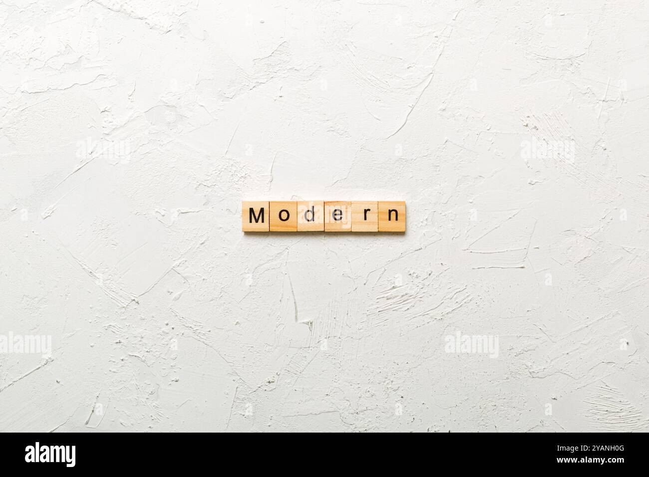 modern word written on wood block. modern text on cement table for your ...