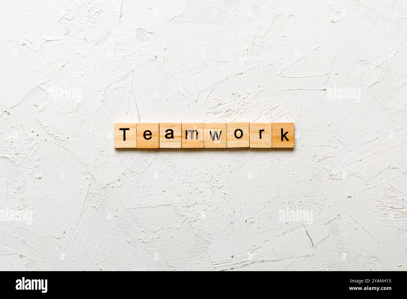 TEAMWORK word written on wood block. TEAMWORK text on cement table for your desing, concept ...