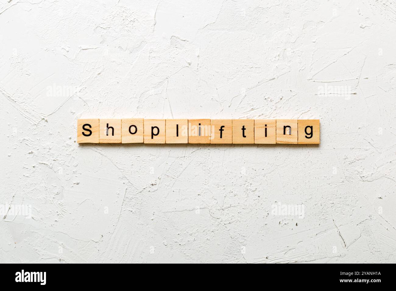 Shoplifting word written on wood block. Shoplifting text on cement ...