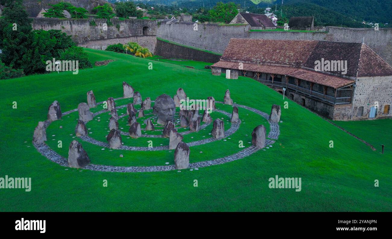 Round Monument with the big head in the middle and the stones around in ...