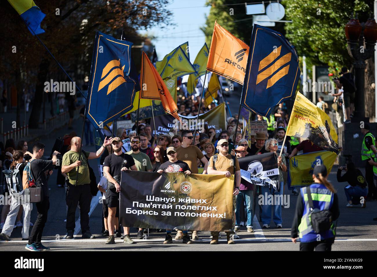 Ukrainian people walk with flags of Azov brigade and 3rd Assault ...