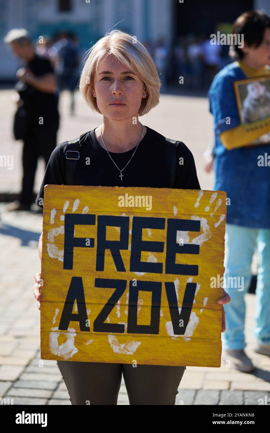 Ukrainian woman posing with a poster Free Azov on a public demonstration in Kyiv - 28 September ...