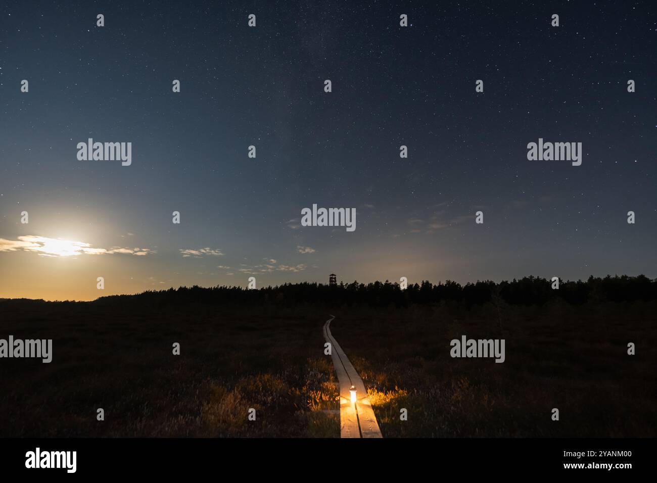 A night scene, a starry sky and the moon behind a cloud, a traveller's ...