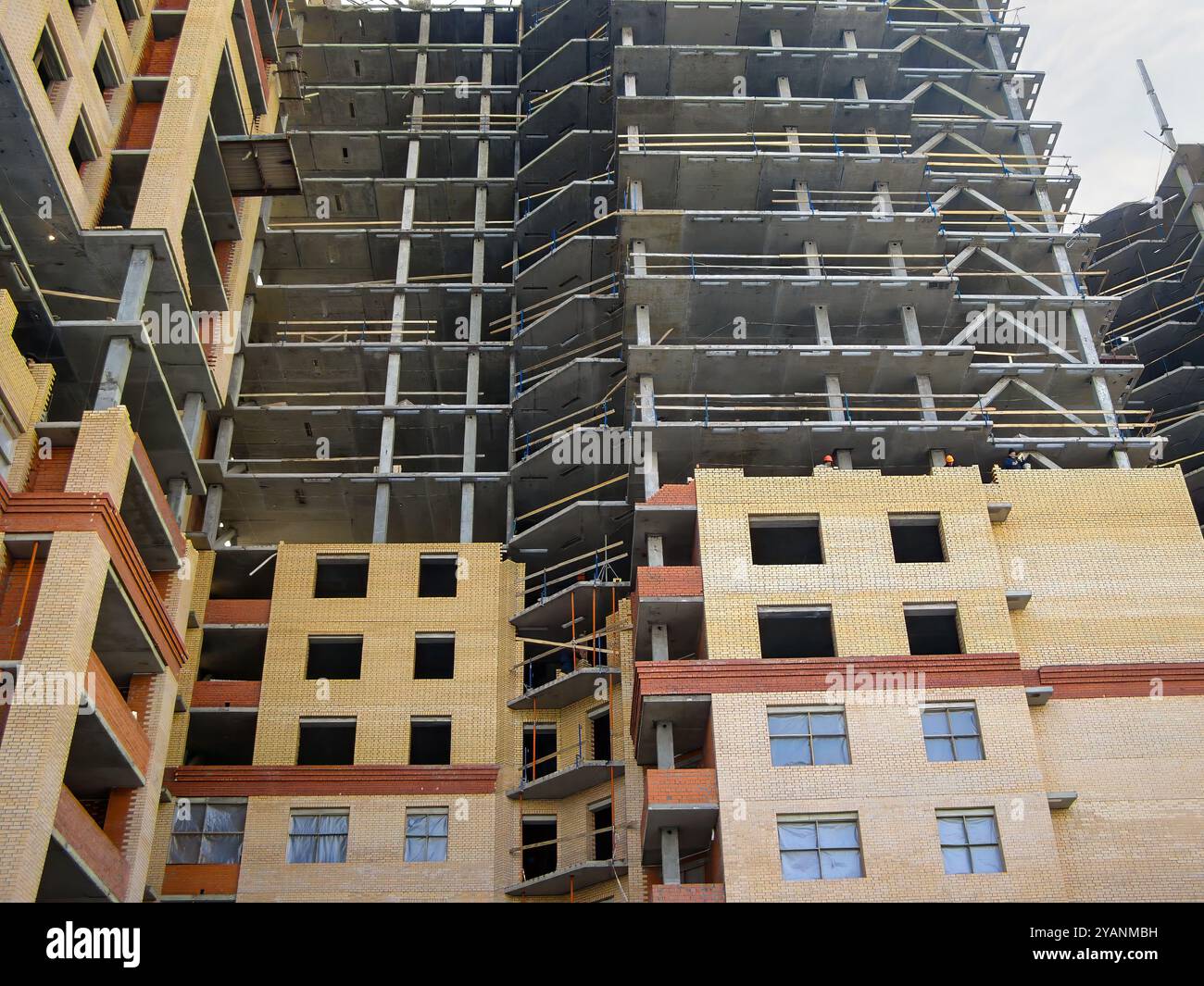 High-rise residential building under construction, with scaffolding and ...