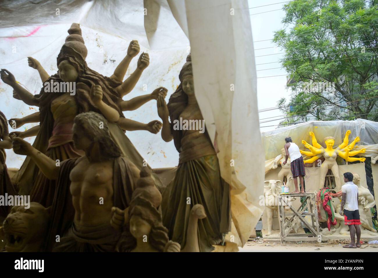 Idol makers adding finishing touches to an idol of the Mother Goddess ...