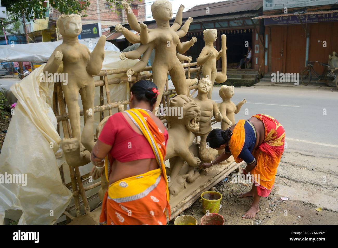 Idol makers adding finishing touches to an idol of the Mother Goddess ...