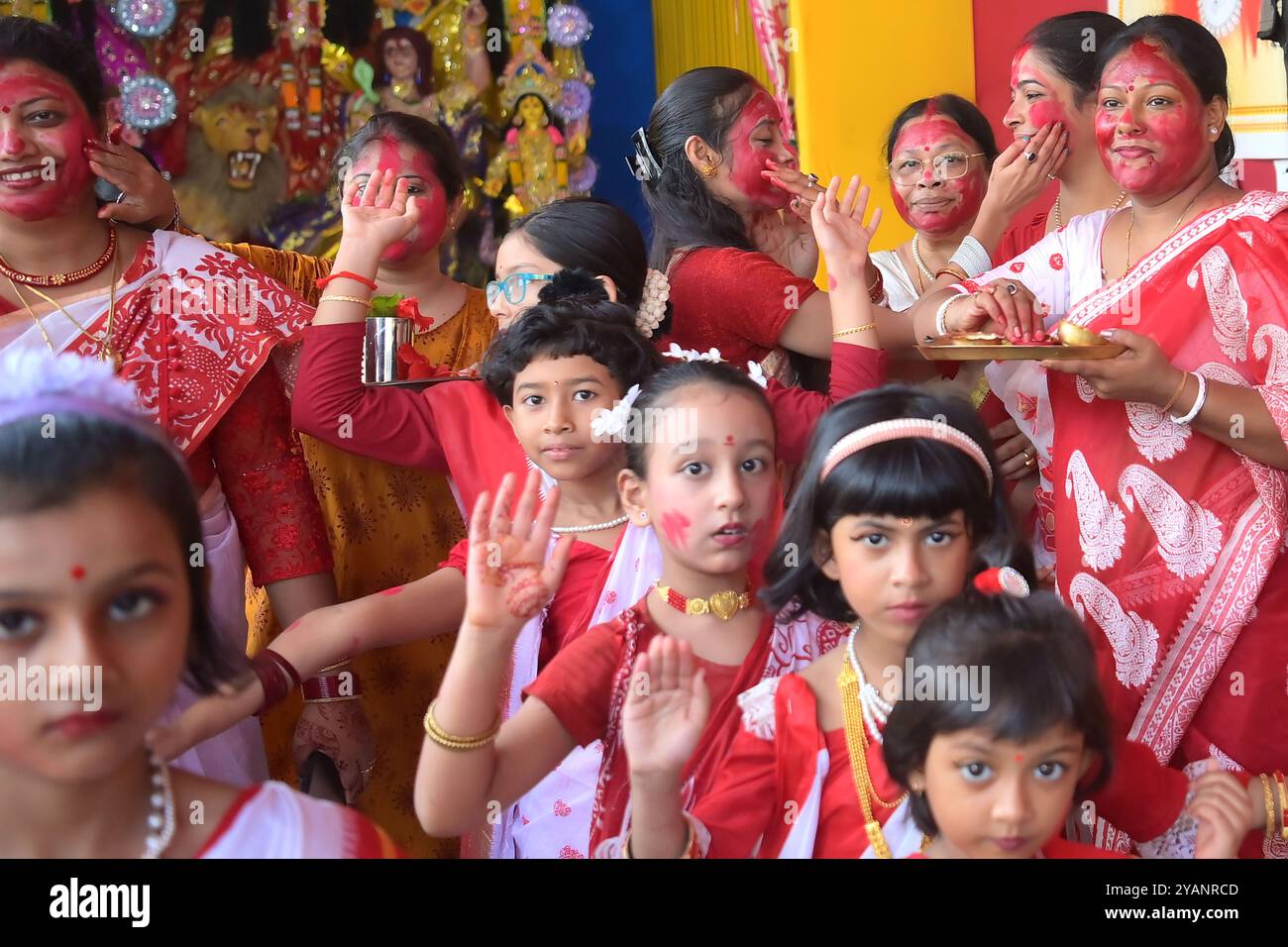 Children and married women are dancing, and the women smear each other ...