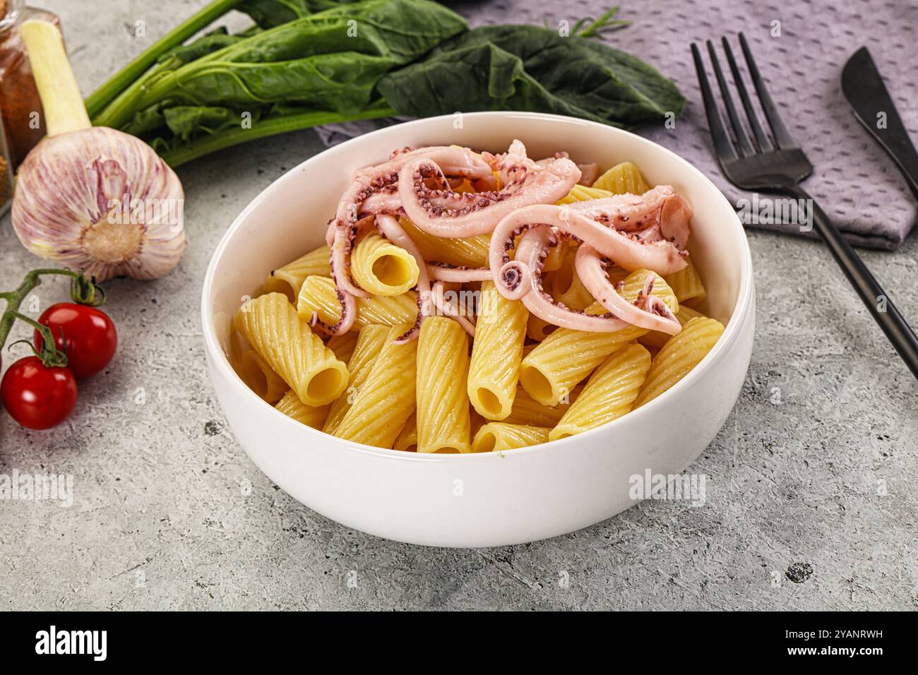 Italian cuisine - pasta tortiglioni with squid tentacles Stock Photo ...