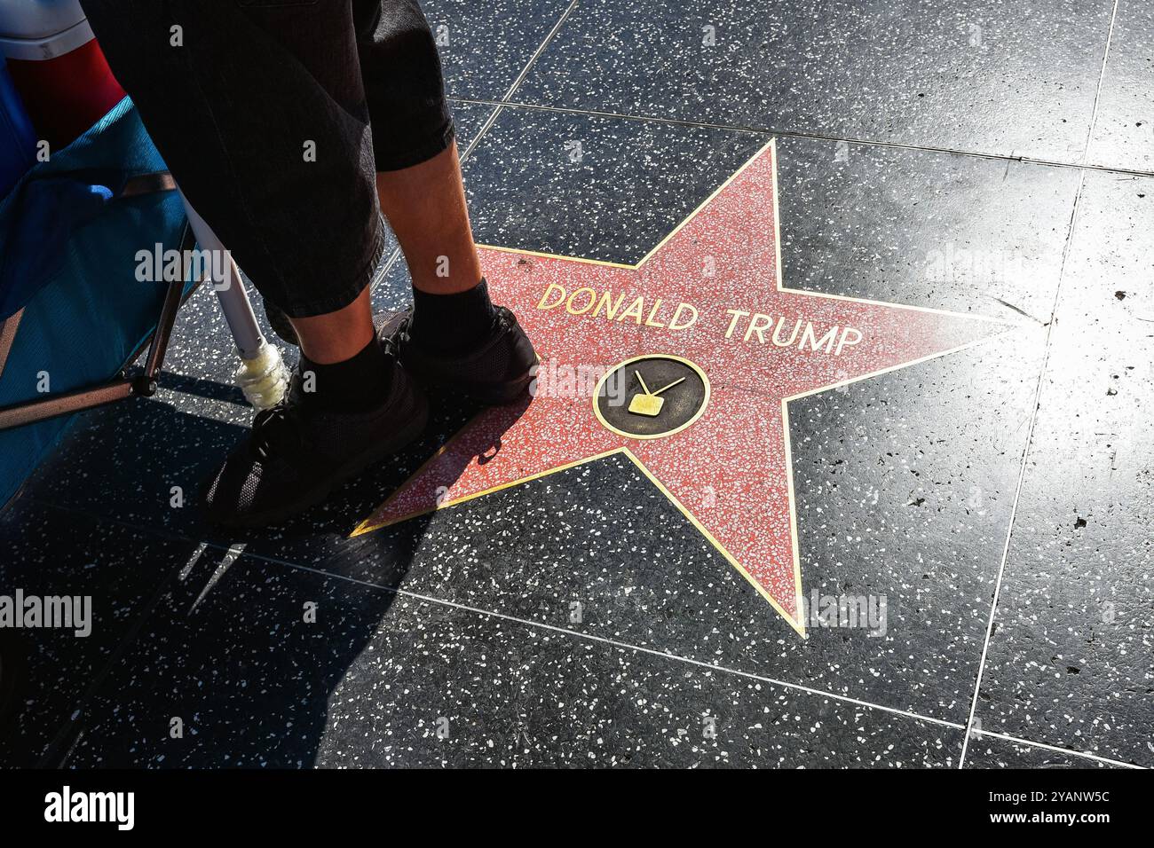 Street vendor trampling on the star of Donald Trump embedded in the ...
