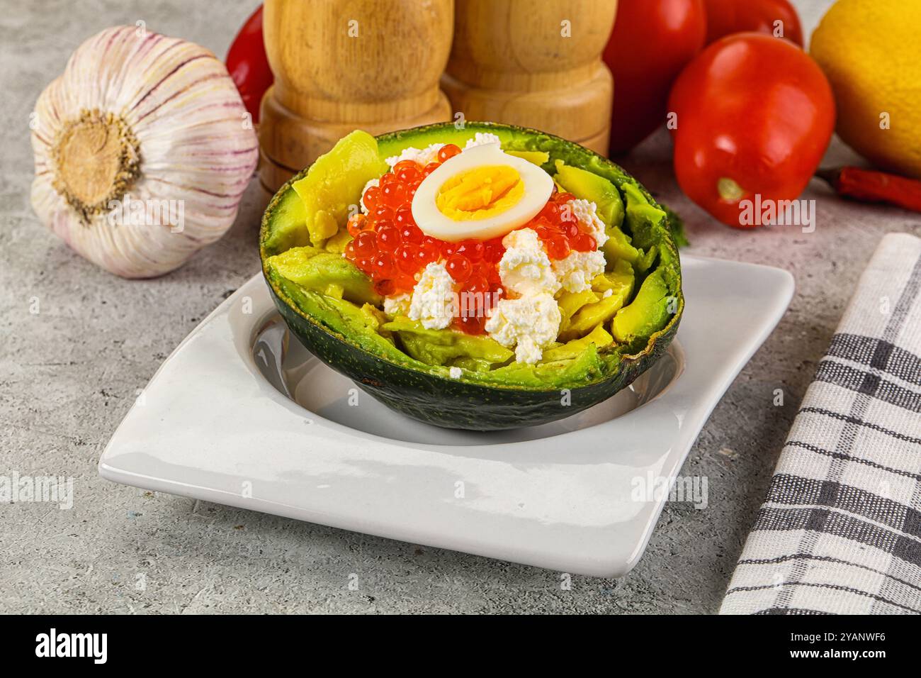 Avocado with red caviar and quil egg and soft cheese Stock Photo - Alamy