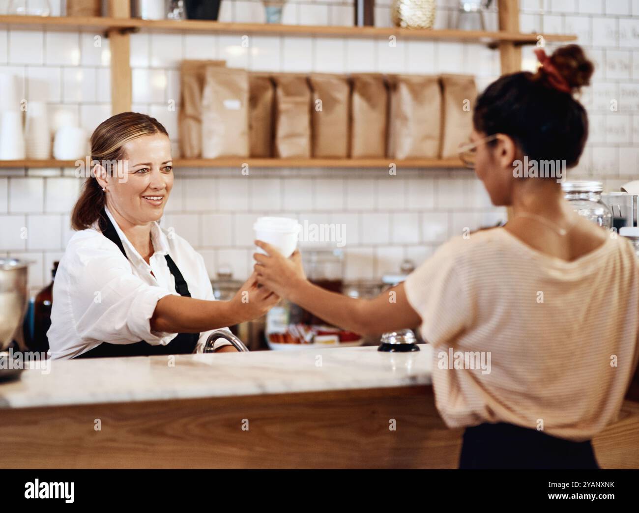 Coffee shop, giving and waitress with woman at counter for drink ...