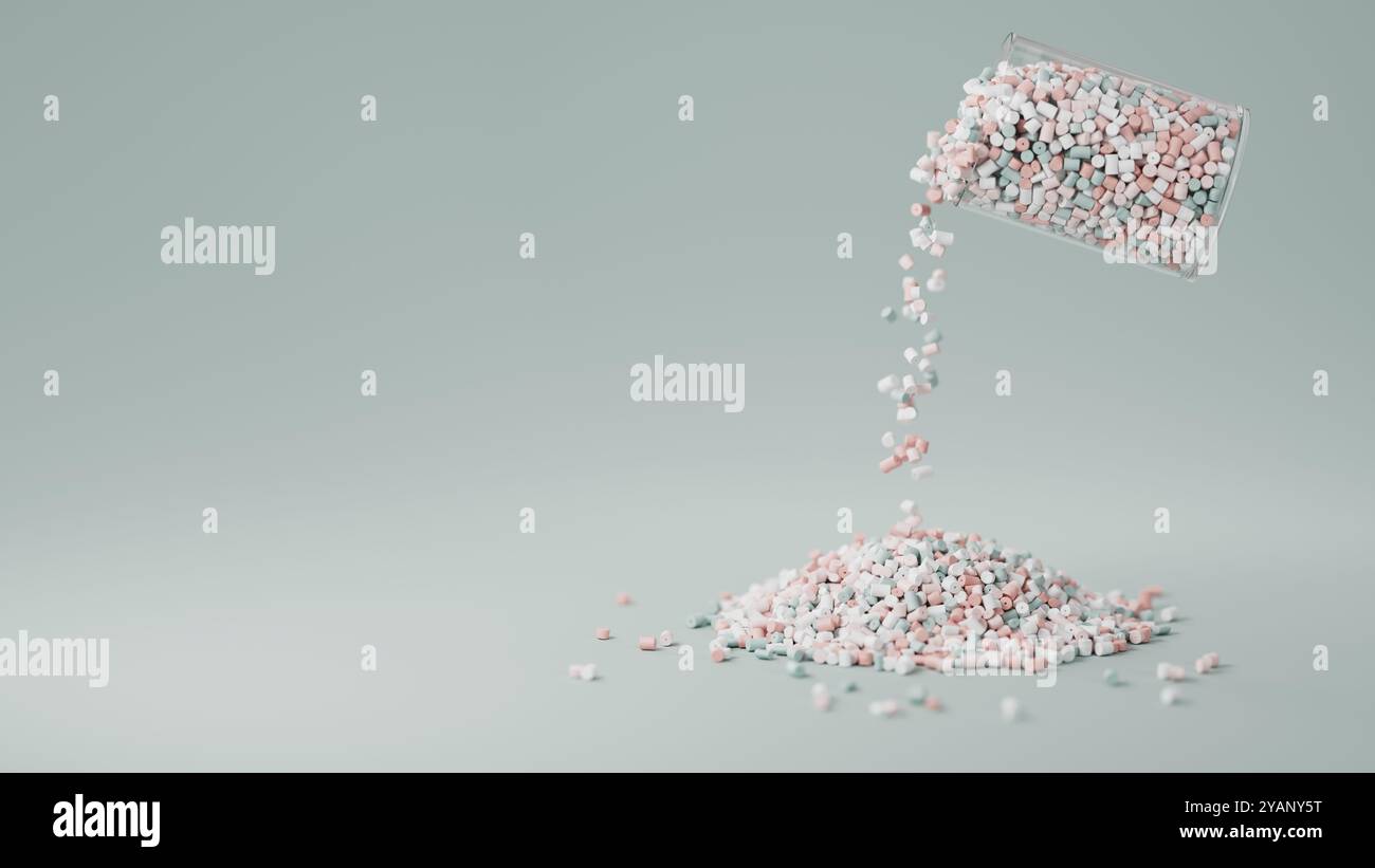 Colorful pastel plastic polypropylene granules pouring from the glass ...