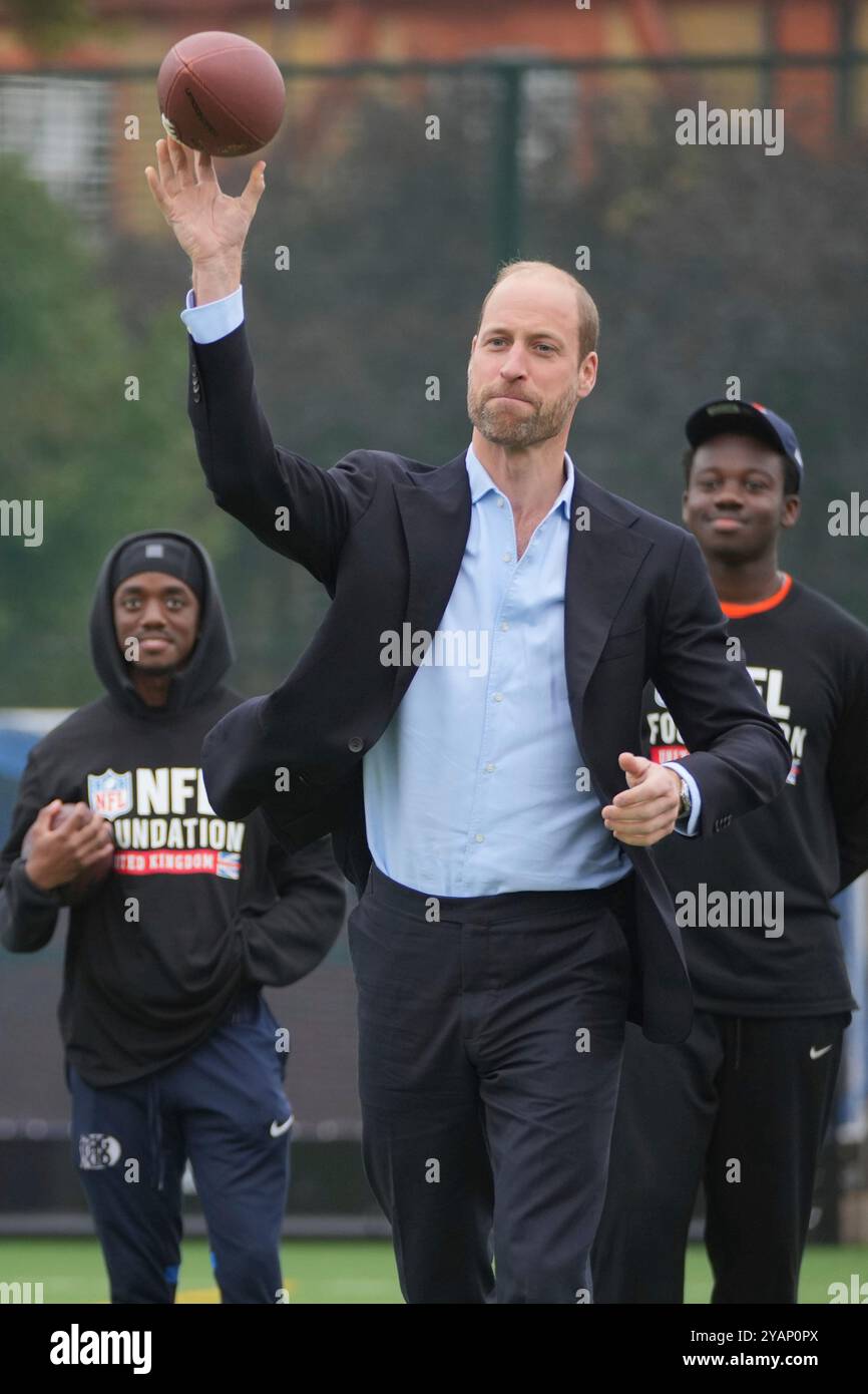Britain's Prince William throws a football as he attends a NFL ...