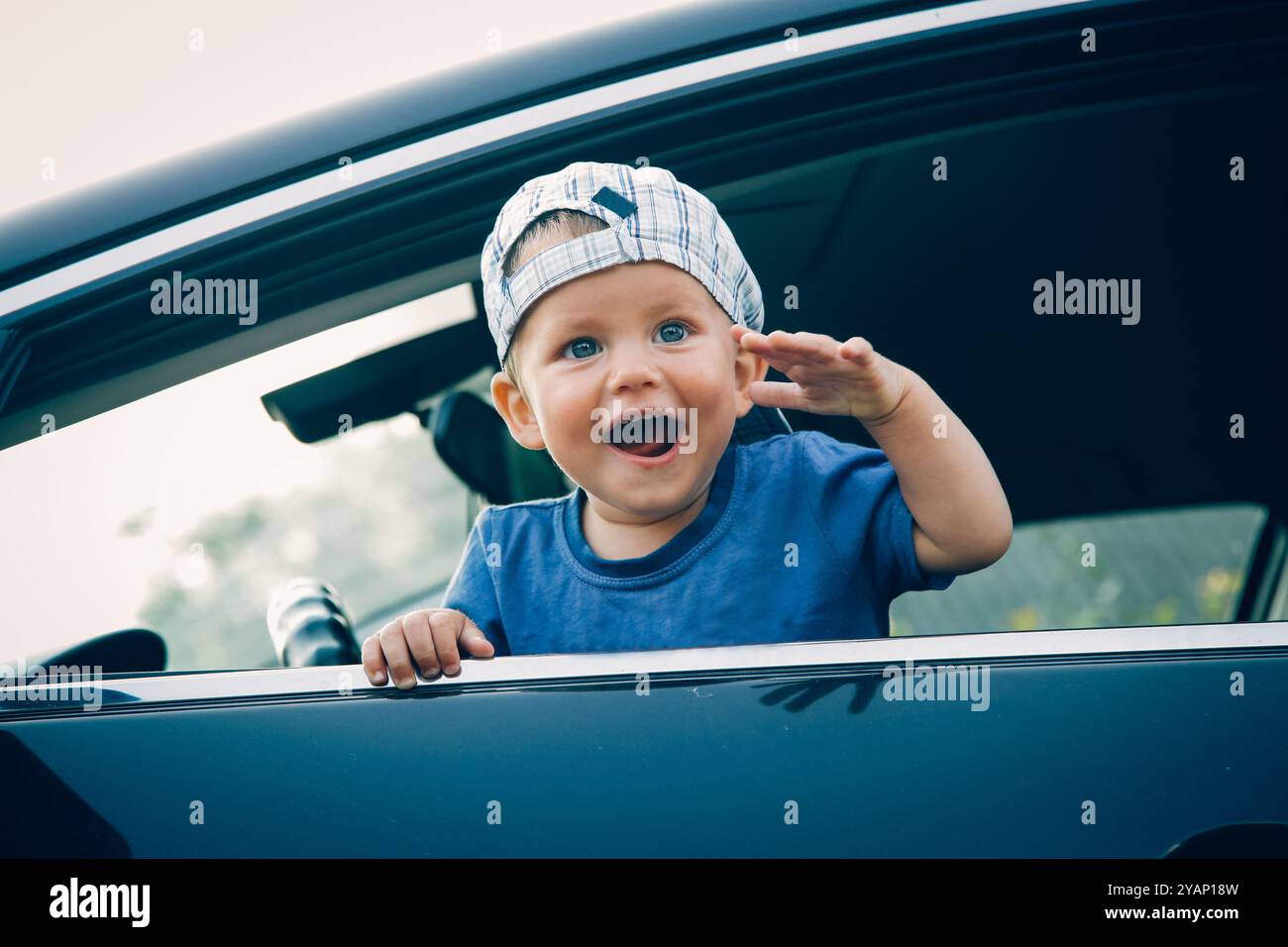 A child looks out the window of a car hi-res stock photography and ...