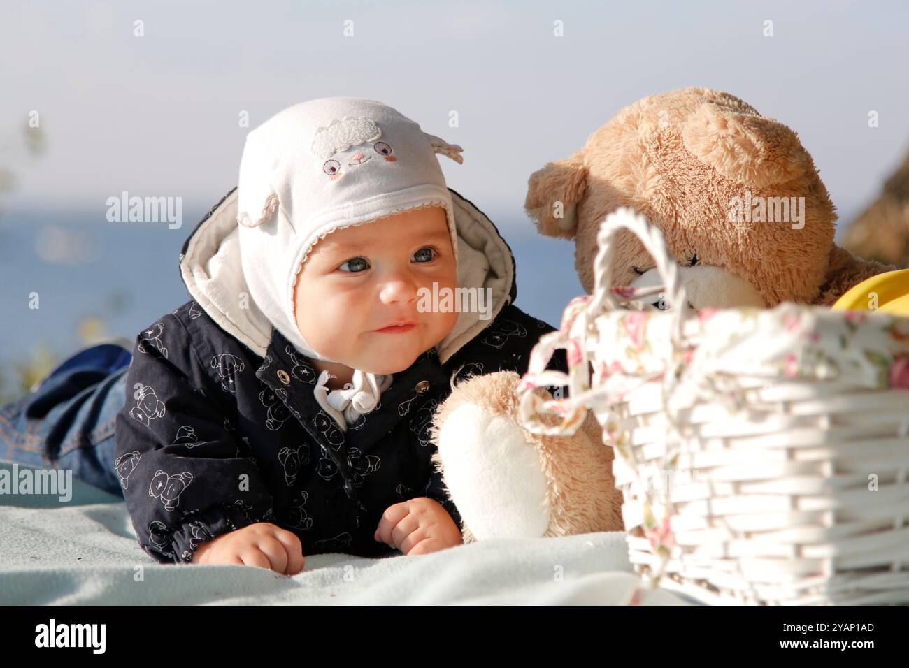 A kid with a teddy bear outdoors Stock Photo - Alamy