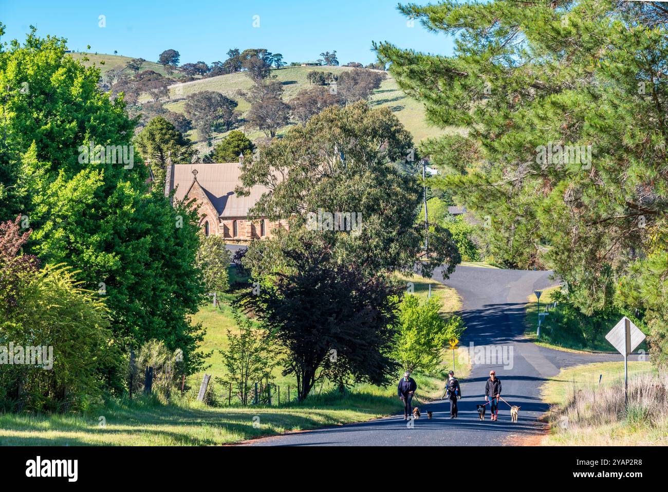 With The Immaculate Conception Catholic Church at the rear people walk ...