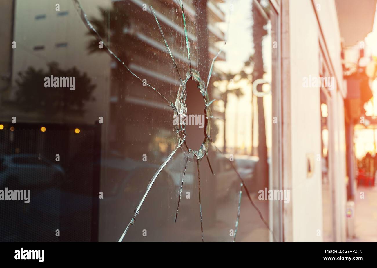 Broken glass in a store on the street. Vandalism and theft concept ...