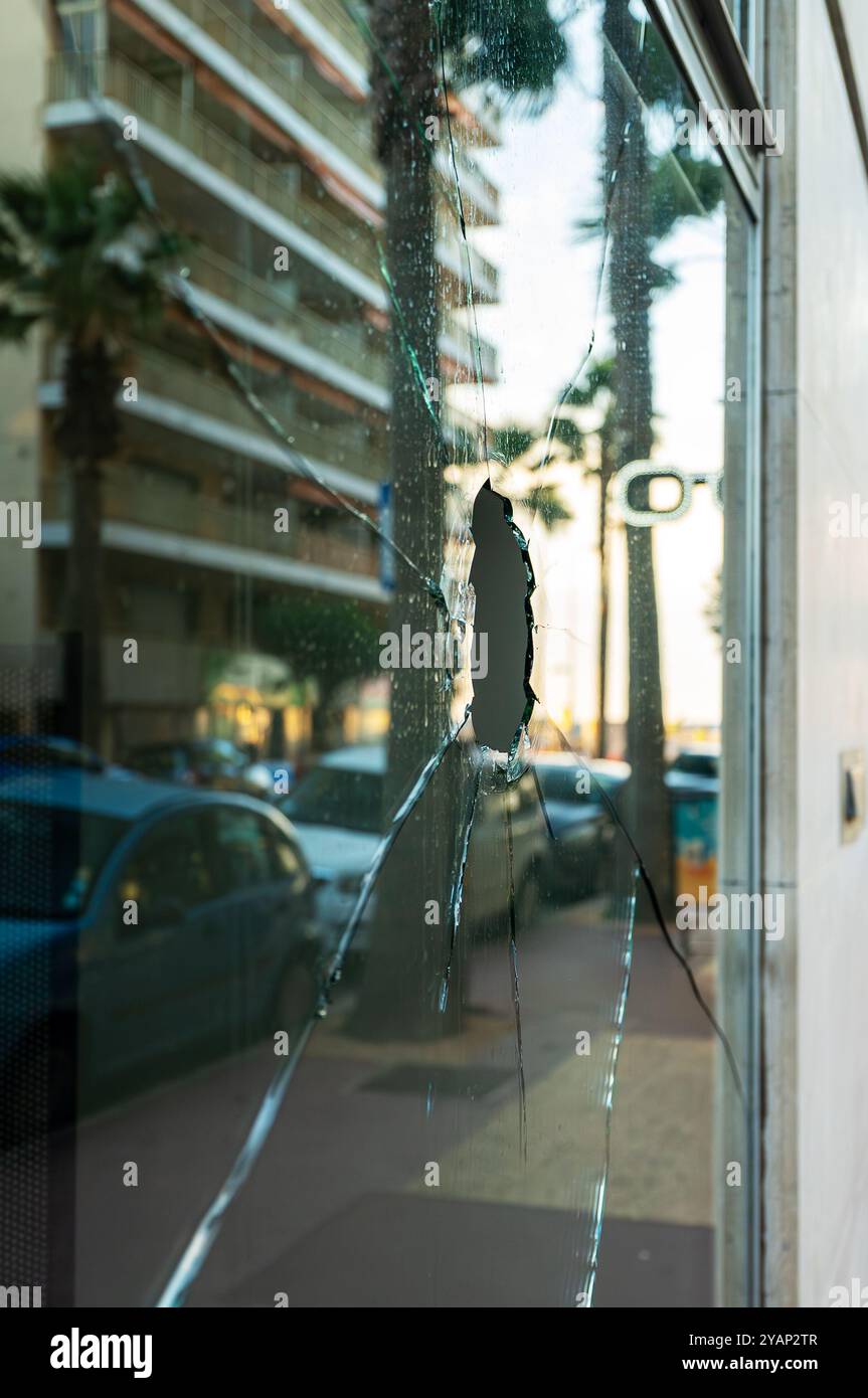 Broken glass in a store on the street. Vandalism and theft concept ...