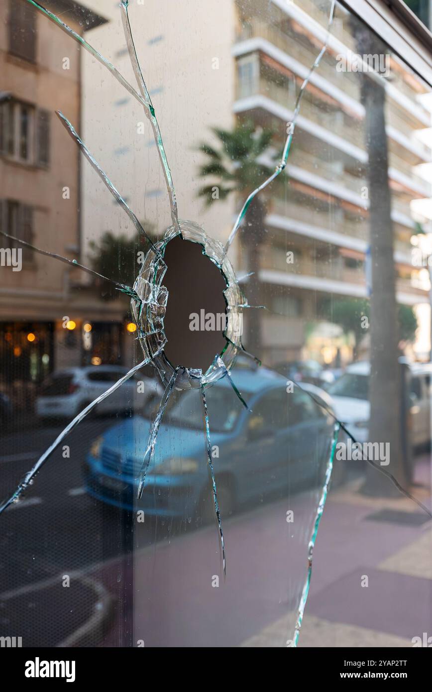 Broken glass in a store on the street. Vandalism and theft concept ...