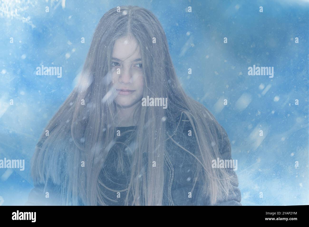 Frozen girl shivering from cold on blue snowy background. Girl during ...