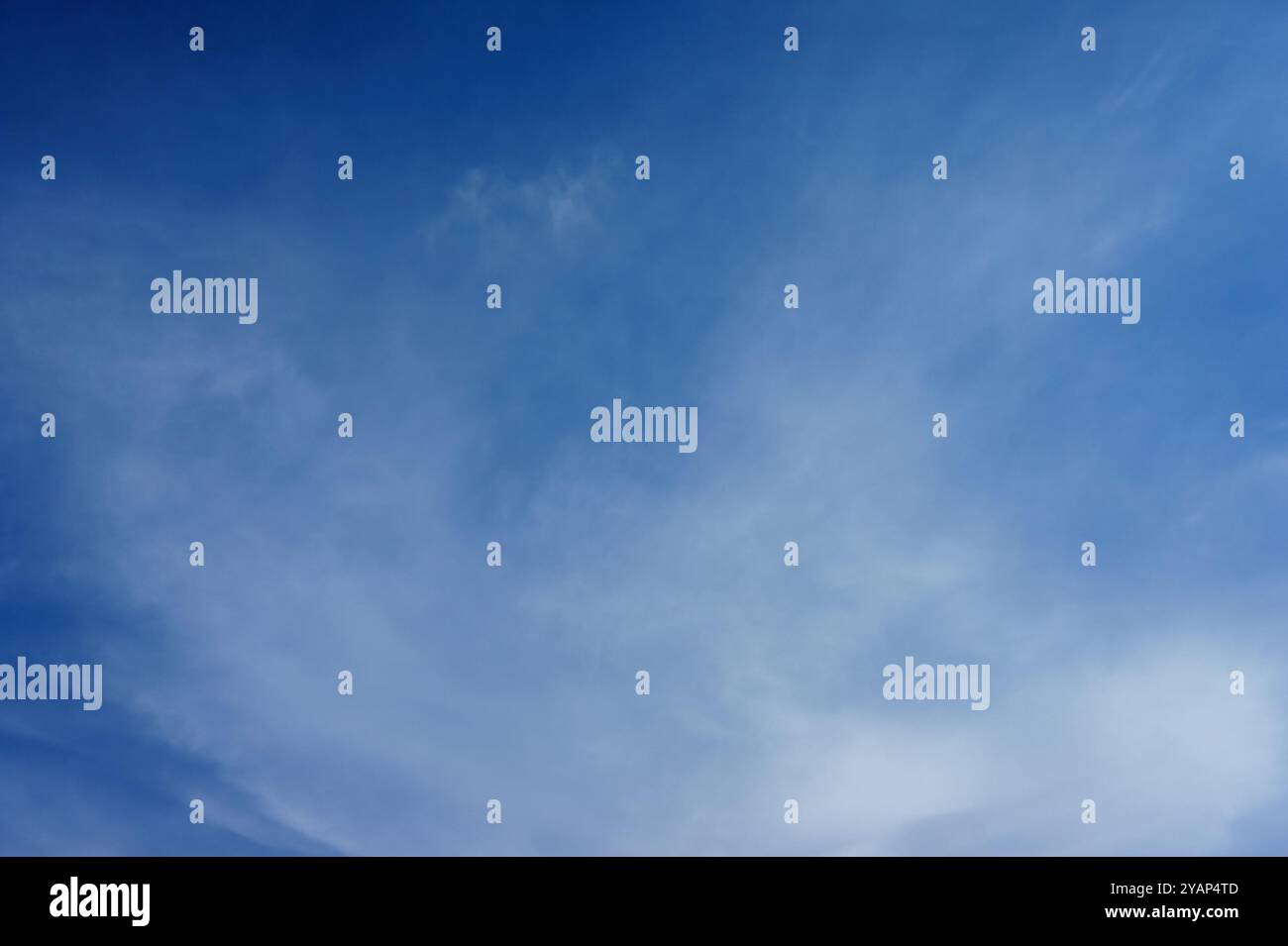 Above, the sky stretches endlessly in a calming blue hue, adorned with ...