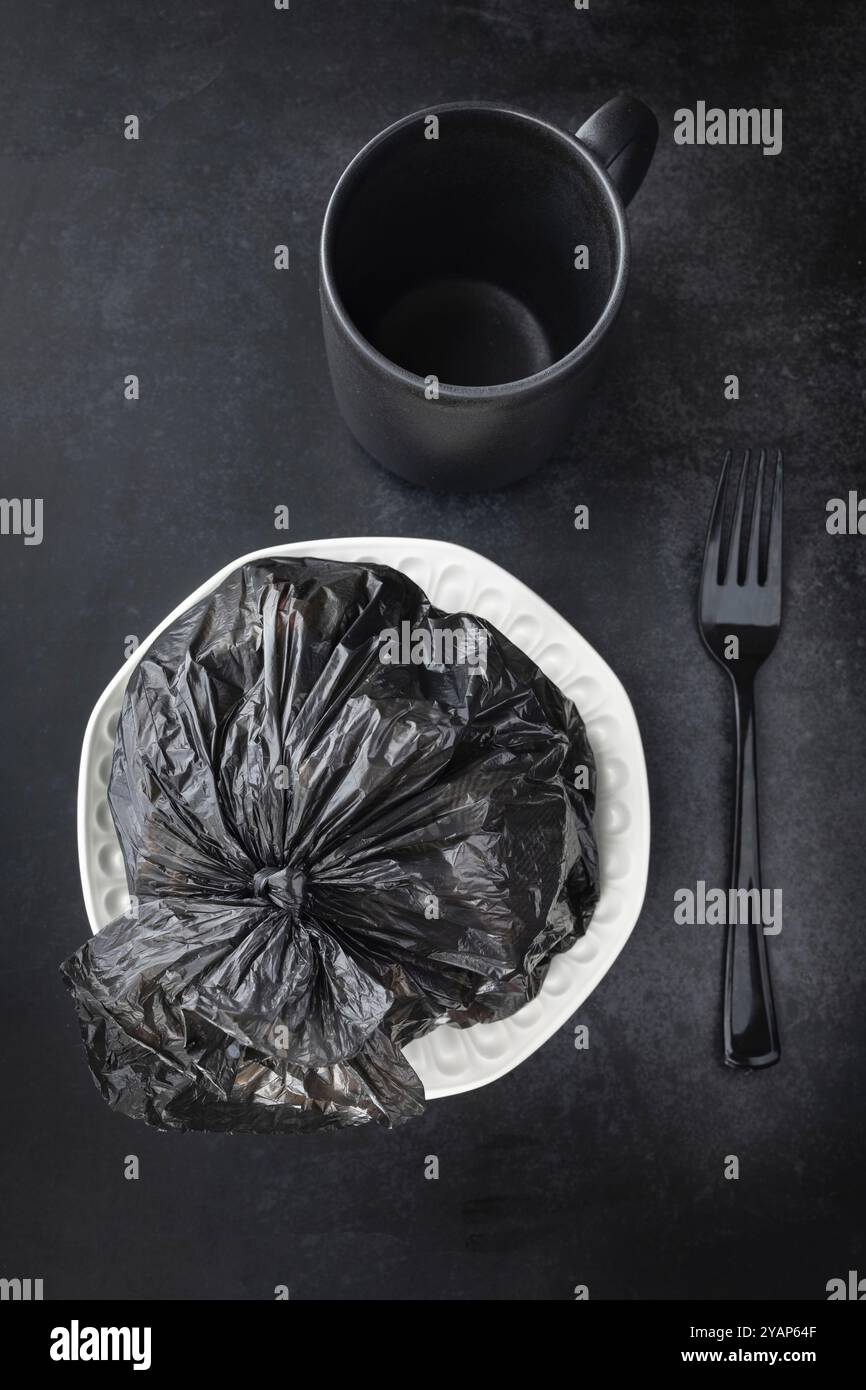 A plate holding a small trash bag, symbolizing the idea of unhealthy ...