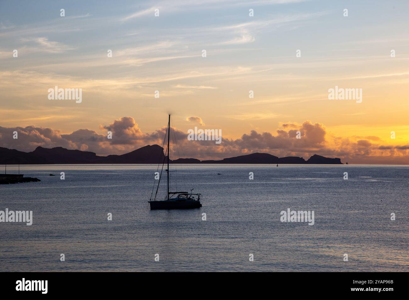 Beautiful golden sunrise over yachts in the harbour at Machico , the ...