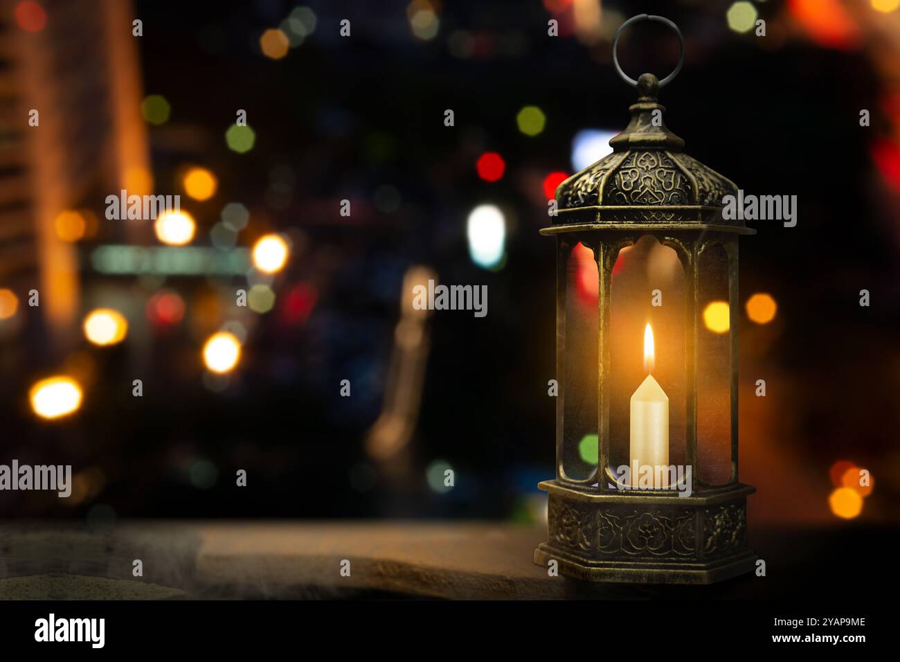 Ornamental arabic lantern with burning candle on the table. Muslim ...