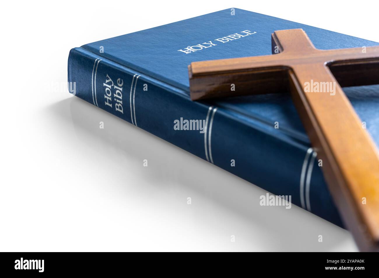 Wooden religion cross and blue book with the word Holy Bible isolated ...