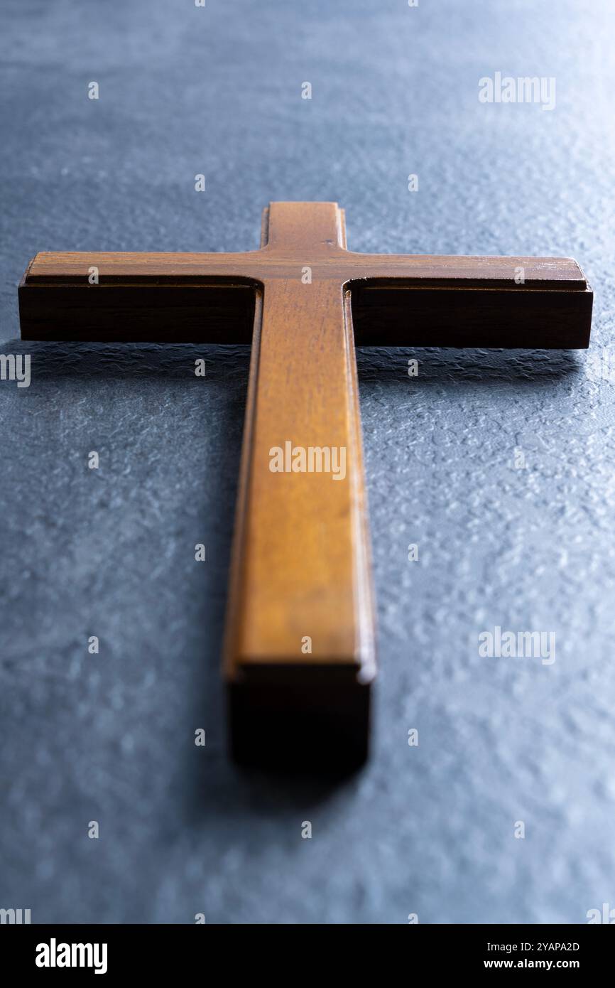 Wooden religion cross on the table. Symbol of faith in God ...