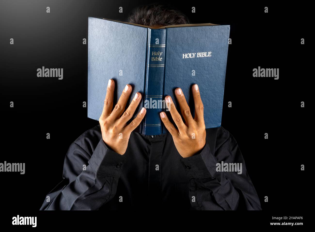 Man reading a holy bible in his hand. Symbol of faith and worship in ...