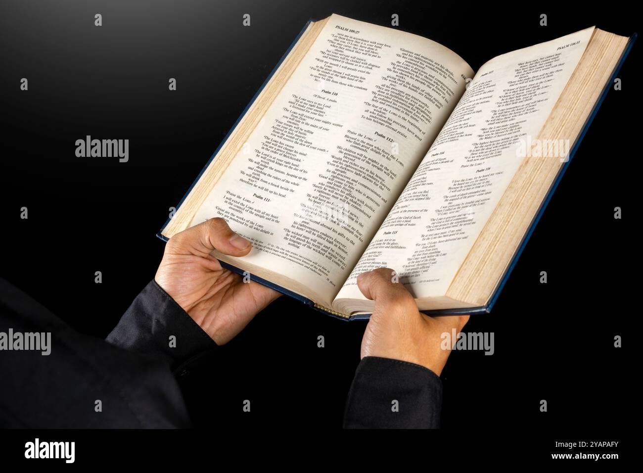 Man reading a holy bible in his hand. Symbol of faith and worship in ...