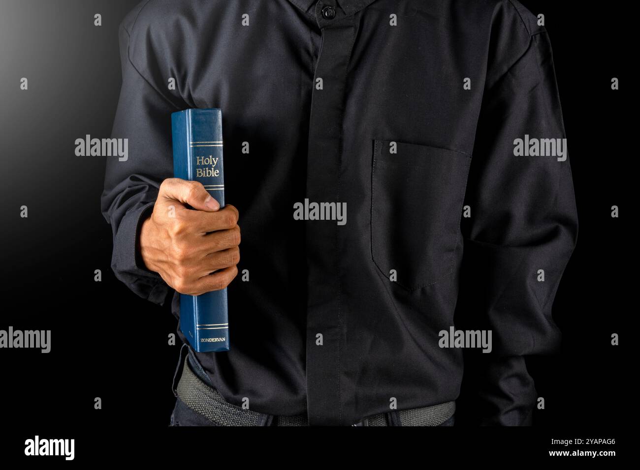 Man holding a holy bible in his hand. Symbol of faith and worship in ...