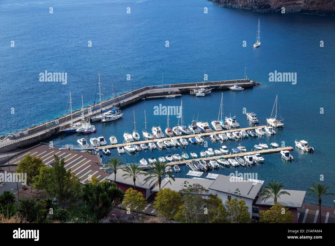 Yachts and boats in the harbour and marina at Machico, the second ...