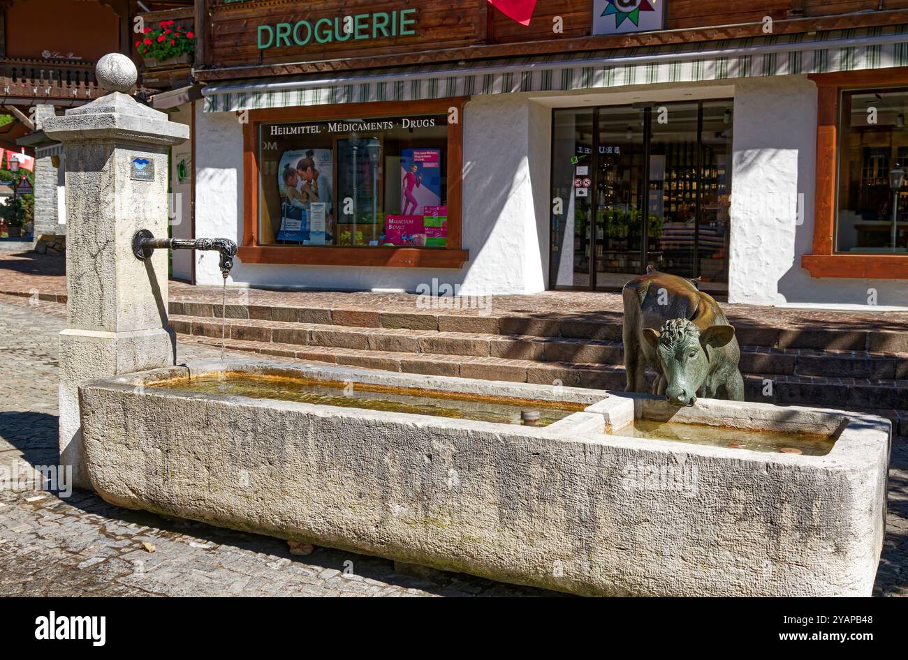 drinking trough, concrete, cow statue at water, street art, Gstaad ...